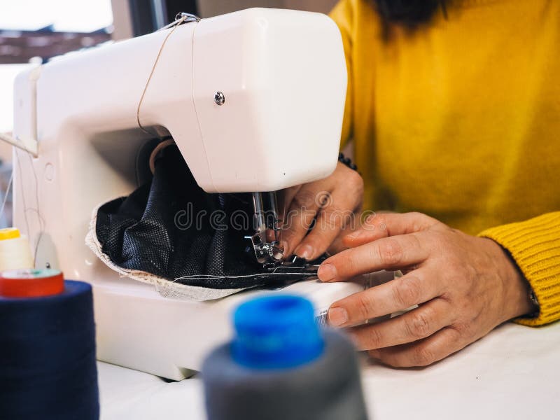 Woman Using Sewing Machine stock photo. Image of hands - 209228954