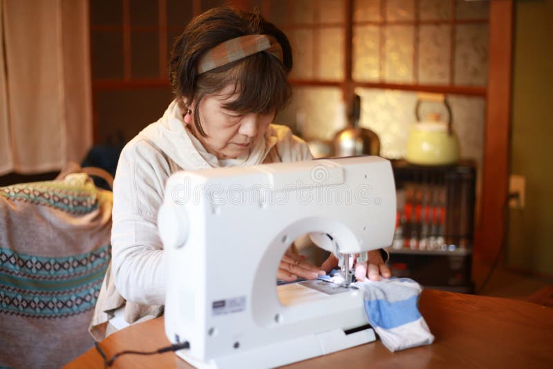 Woman Using a Sewing Machine Stock Image - Image of clothes, bright ...