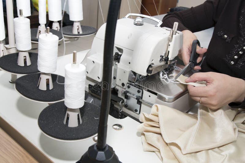 Woman using sewing machine stock image. Image of sewing - 40042237