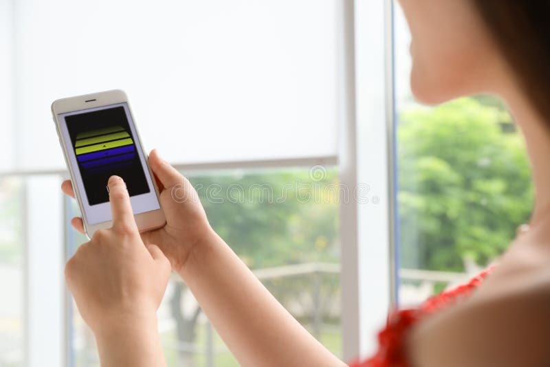 Woman Using Smart Home Application on Phone To Control Window Blinds ...
