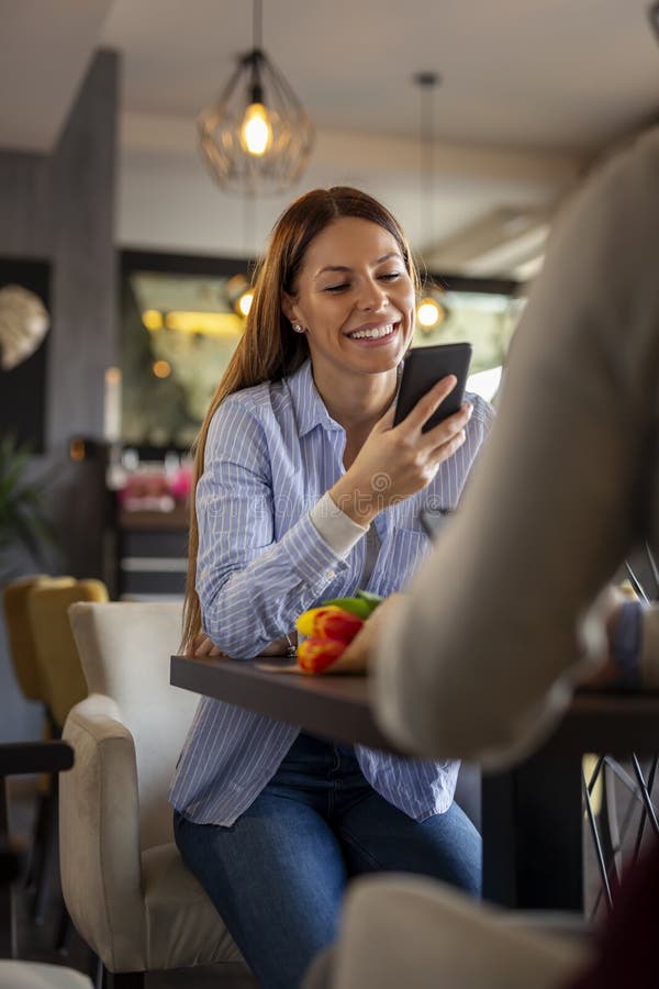 Woman Using Smart Phone on a Date Stock Photo - Image of flowers ...