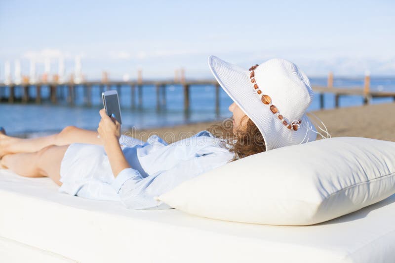 Woman Using Smartphone on the Beach Stock Image - Image of holiday ...