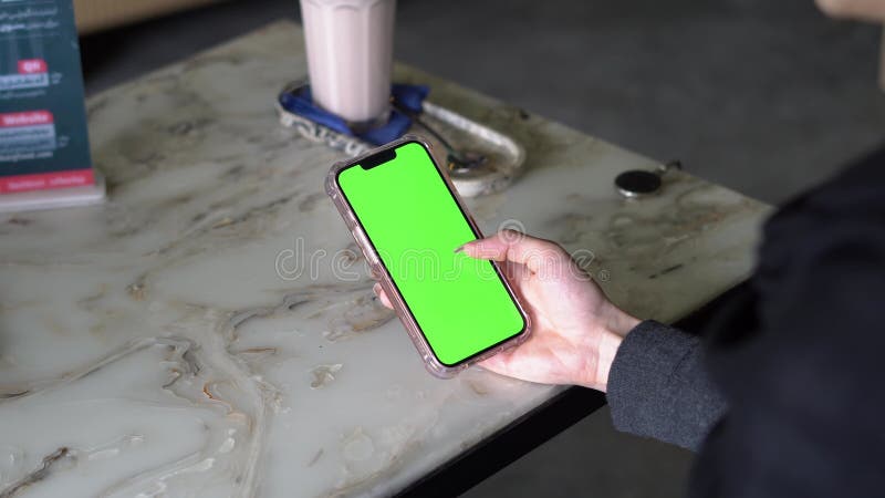 Woman Using Smartphone in Vertical Mode with Green Mock-up Screen ...
