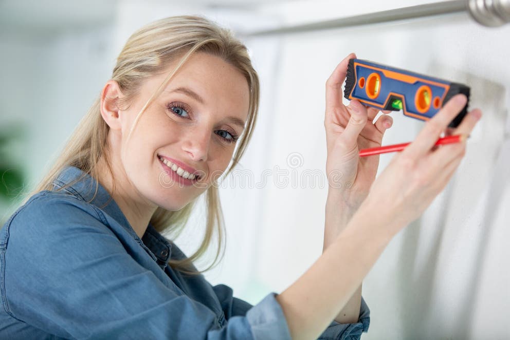 Woman Using Spirit Level and Marking Wall Stock Photo - Image of spirit ...