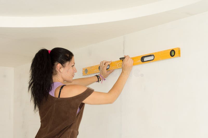 Woman Using Spirit Level To Work Out Measurements Stock Image - Image ...