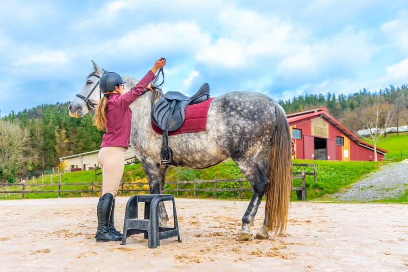Woman Using a Step To Ride a Horse Stock Photo - Image of equine ...