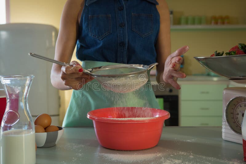 Woman Using Strainer in Kitchen Stock Image - Image of house, domicile ...