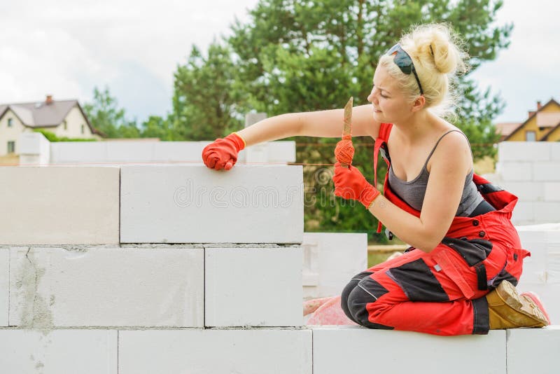 Woman Using String As Level in Wall Construction Stock Photo - Image of ...