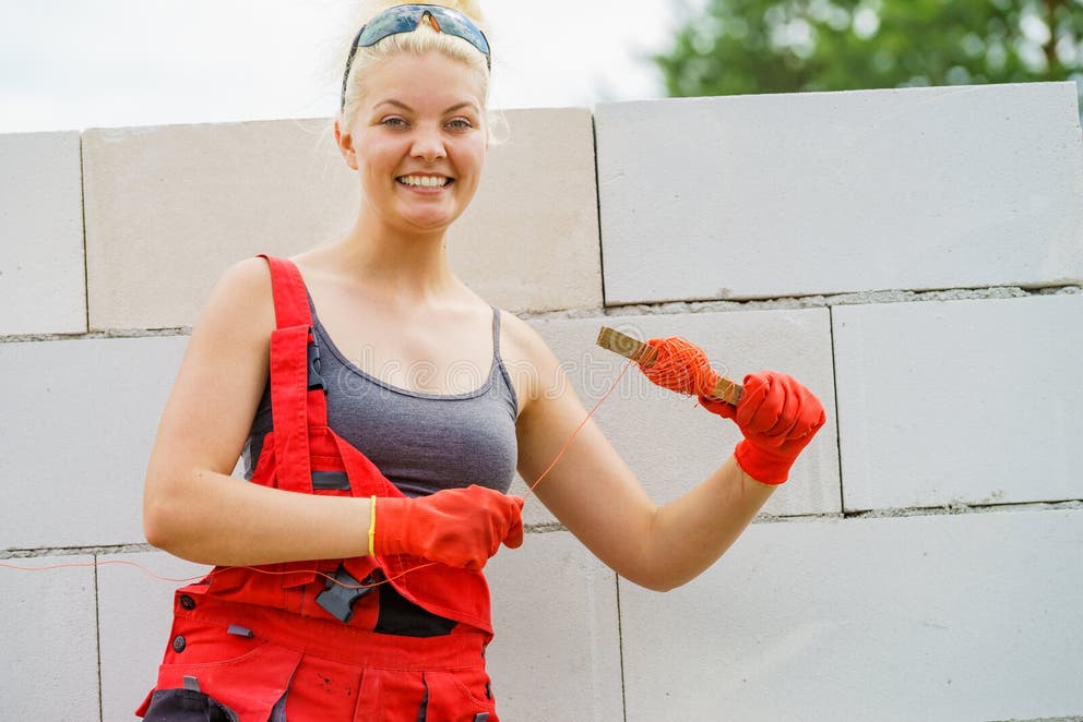 Woman Using String As Level in Wall Construction Stock Photo - Image of ...