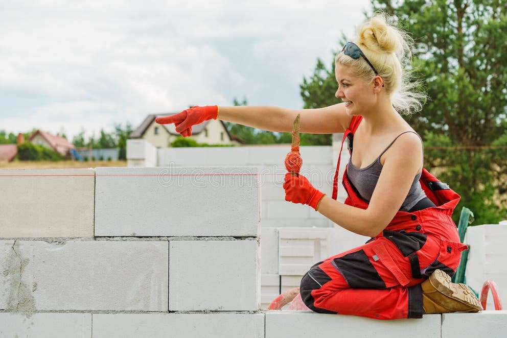 Woman Using String As Level in Wall Construction Stock Photo - Image of ...
