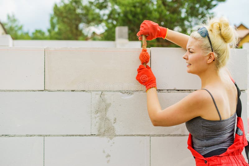 Woman Using String As Level in Wall Construction Stock Image - Image of ...