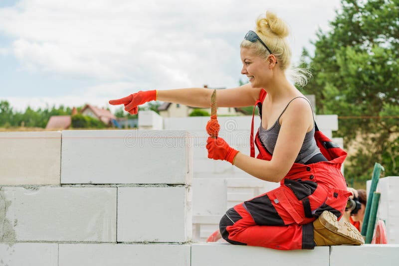 Woman Using String As Level in Wall Construction Stock Image - Image of ...