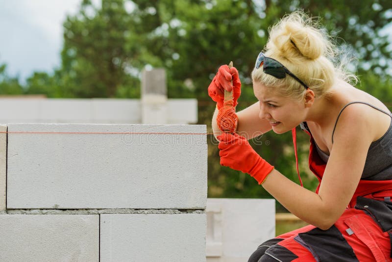 Woman Using String As Level in Wall Construction Stock Photo - Image of ...