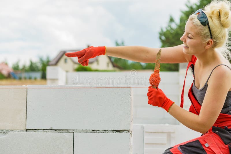 Woman Using String As Level in Wall Construction Stock Image - Image of ...