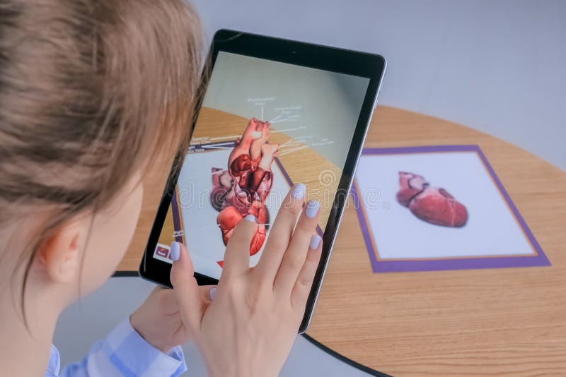 Woman Using Tablet with Augmented Reality App - 3d Model of Human Heart ... Woman Using Tablet with Augmented Reality App - 3d Model of Human Heart ...
