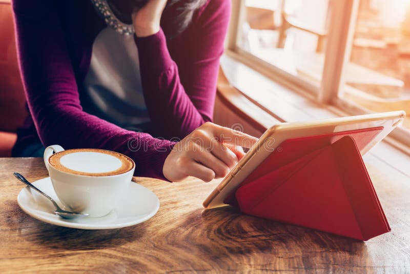Woman Using Tablet Computer in Coffee Shop Stock Photo - Image of ...
