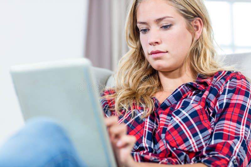 Woman Using Tablet Computer Stock Image - Image of sitting, homey: 66159757