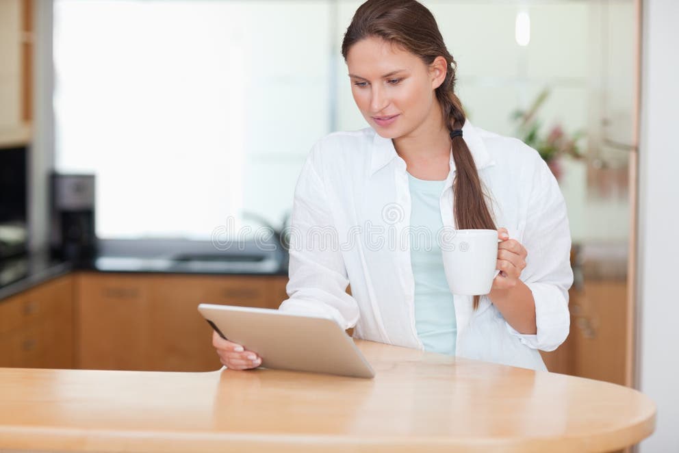 Woman Using a Tablet Computer while Drinking Tea Stock Image - Image of ...