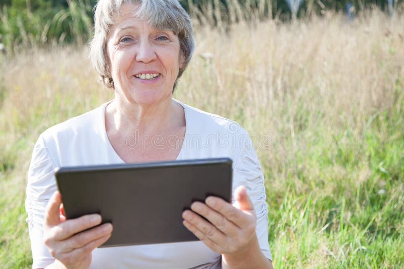 Woman using tablet device stock image. Image of woman - 60368145 Woman using tablet device stock image. Image of woman - 60368145