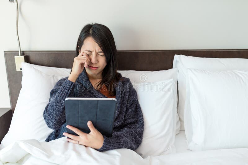 Woman Using Tablet and Feeling Eye Pain and Lying on Bed Stock Photo ...