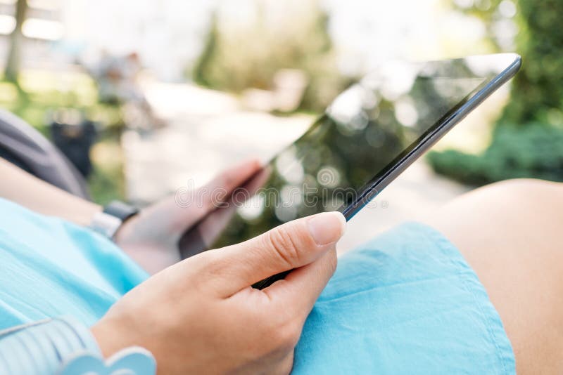 Woman Using Tablet Outdoor. Stock Image - Image of person, touch: 127149189