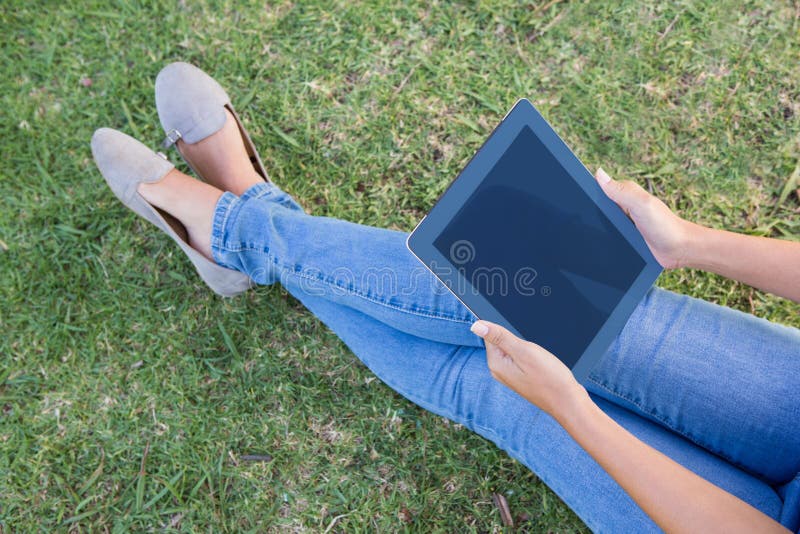 Woman using tablet in park stock image. Image of bright - 50487471
