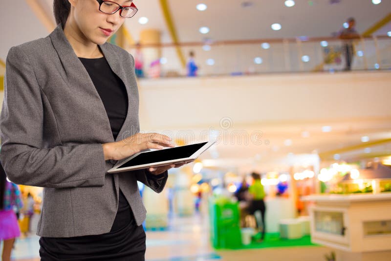 Woman Using Tablet in Shopping Mall. Stock Image - Image of tablet ...