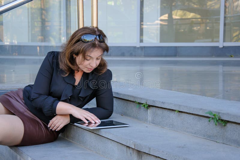Woman Using a Tablet on Stairs of Office Building Stock Image - Image ...