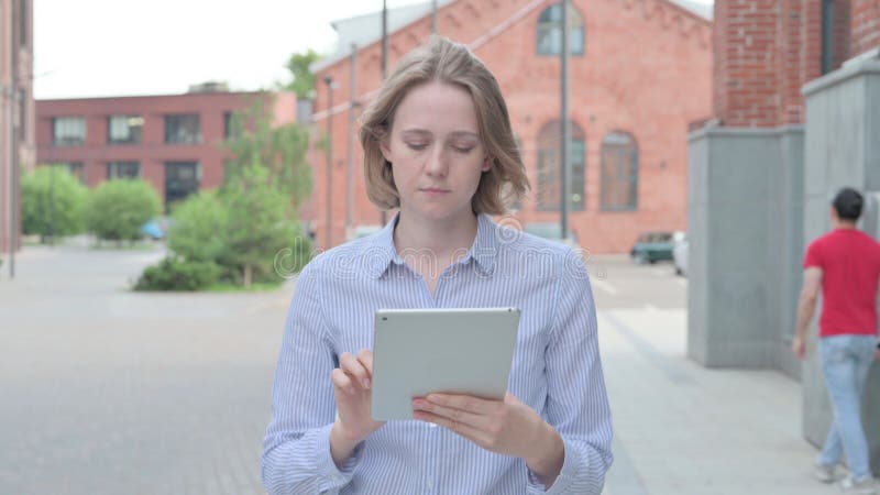 Woman Using Tablet while Walking on the Street Stock Image - Image of ...