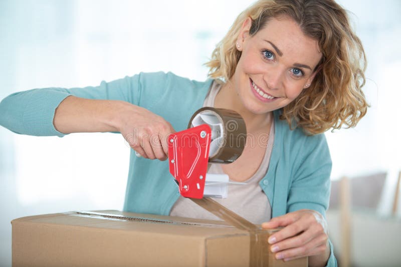 Woman Using Tape Dispenser To Seal Cardboard Box Stock Photo - Image of ...