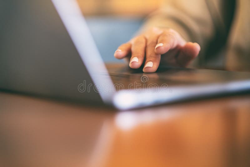 A Woman Using and Touching on Laptop Computer Touchpad on Wooden Table ...