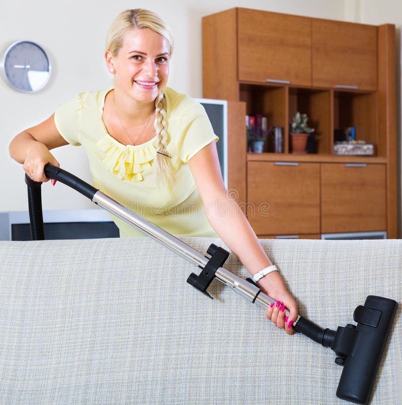 Woman using vacuum cleaner stock image. Image of face - 70040047