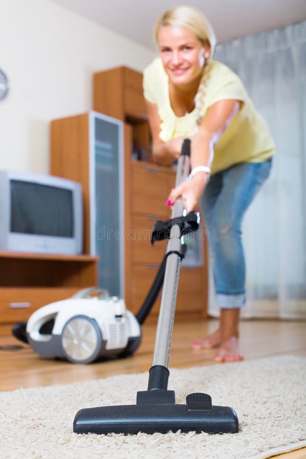 Woman using vacuum cleaner stock image. Image of domestic - 65093995