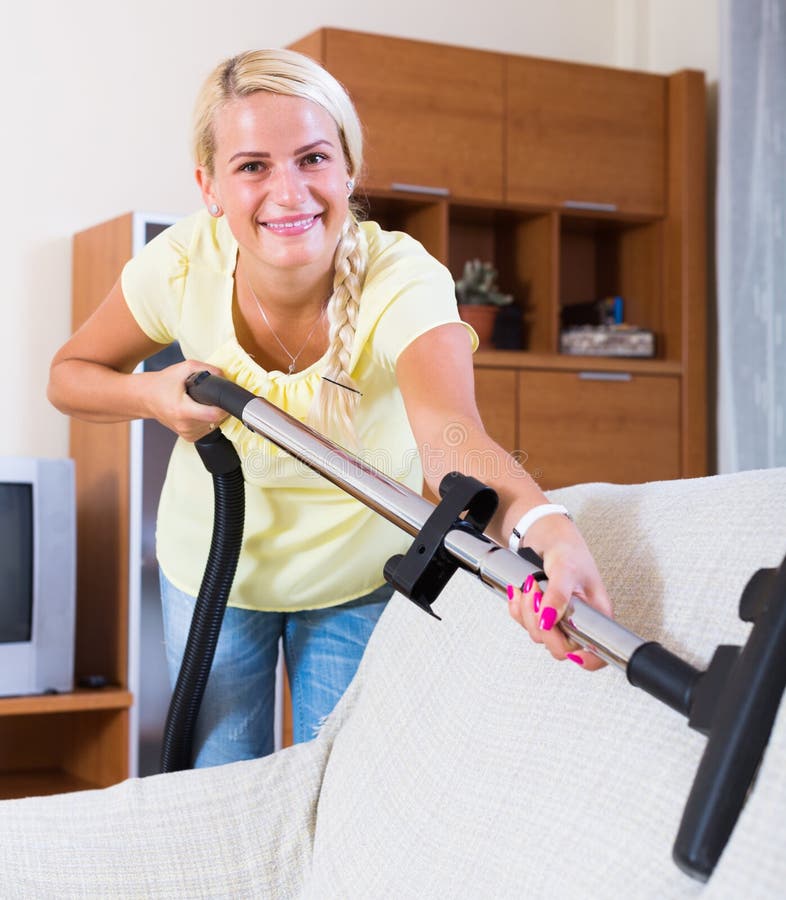 Woman using vacuum cleaner stock photo. Image of hoover - 60825328