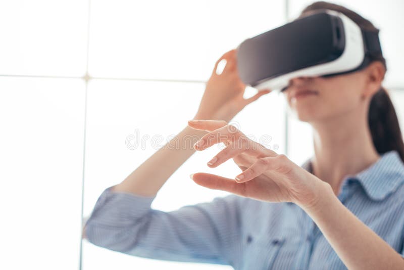 Woman using a VR headset stock image. Image of technology - 92742719