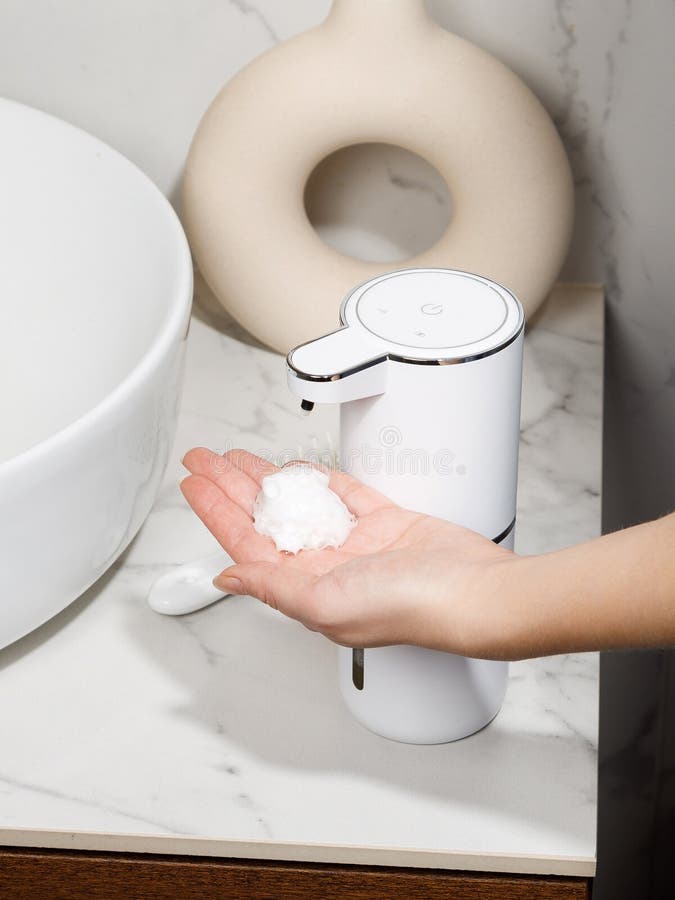 Woman Using White Automatic Soap Dispenser in Bathroom Stock Photo ...