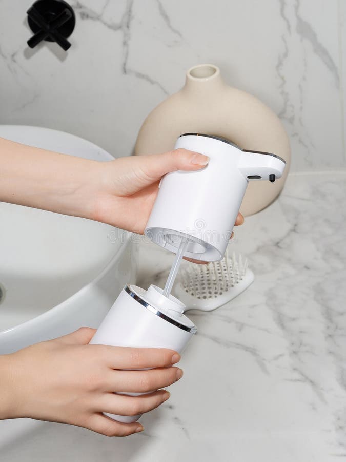 Woman Using White Automatic Soap Dispenser in Bathroom Stock Photo ...