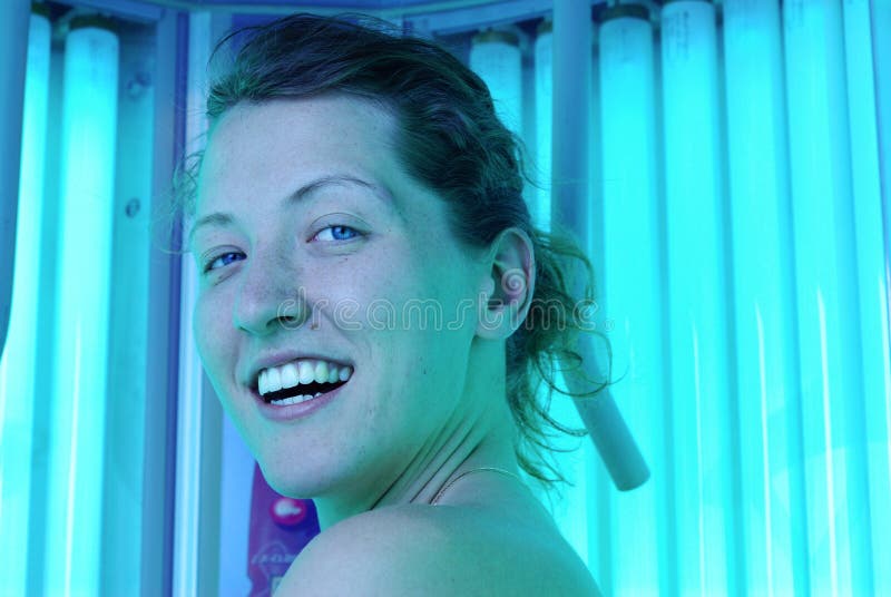 Woman in vertical solarium stock photo. Image of health - 13928676