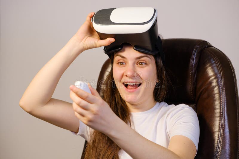 A Woman In Virtual Reality Glasses Looks At The Remote Control Stock Image Image Of