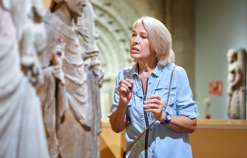Woman Visitor in Historical Museum Looking at Art Object. Editorial ...