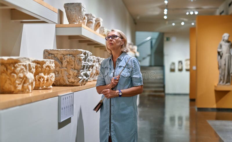 Woman Visitor in Historical Museum Looking at Art Object. Editorial ...