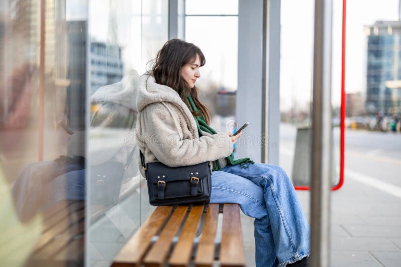 Woman Waiting for a Bus at the Bus Stop in the City Stock Photo - Image ...
