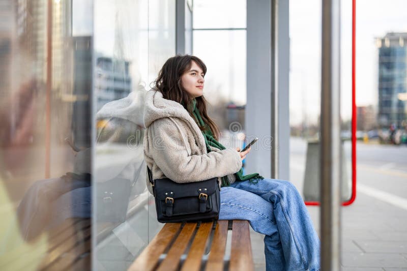 Woman Waiting for a Bus at the Bus Stop in the City Stock Image - Image ...