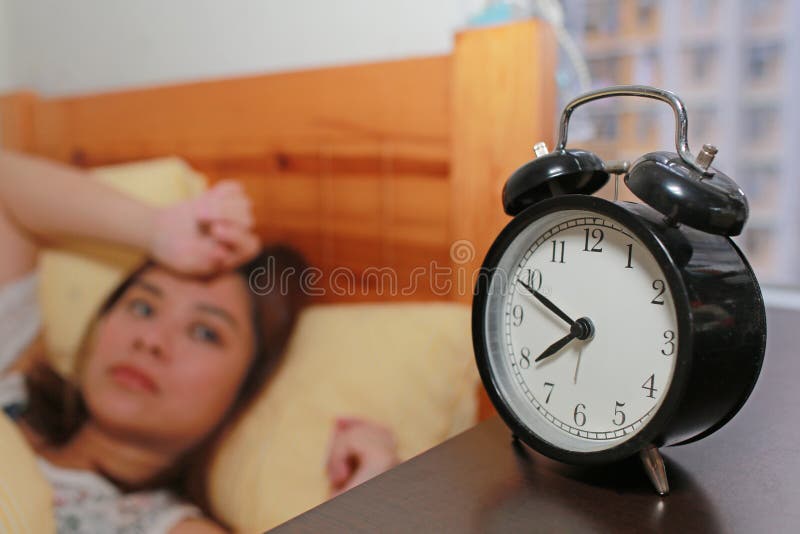 Woman wake up by the clock stock photo. Image of clock - 205247712