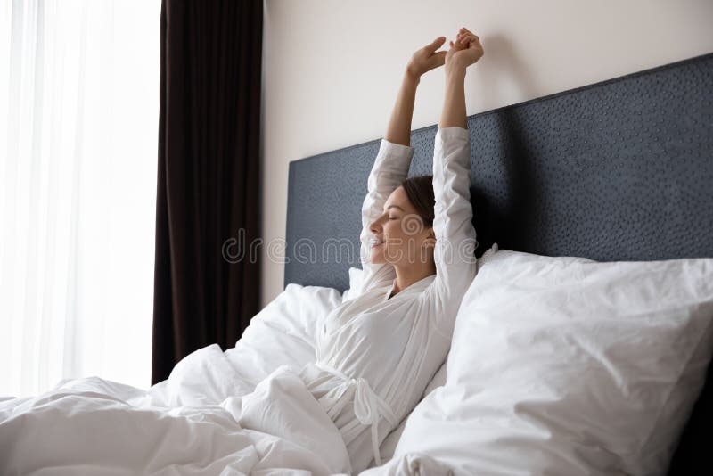 Woman Wake Up Seated In Bed Do Morning Stretching Exercises Stock Image