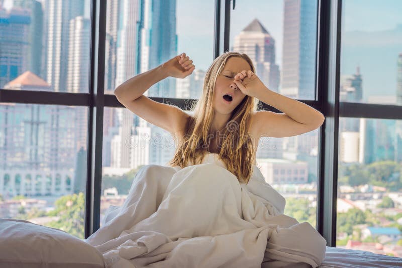 Woman Wakes Up in the Morning in an Apartment in the Downtown Ar Stock ... Woman Wakes Up in the Morning in an Apartment in the Downtown Ar Stock ...
