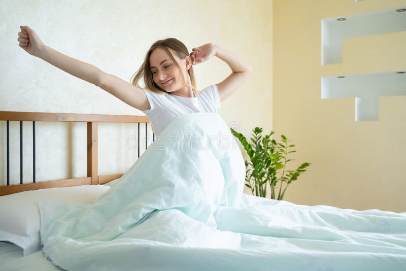 Woman Waking Up In Her Bed Fully Rested Woman Stretching In Bed After