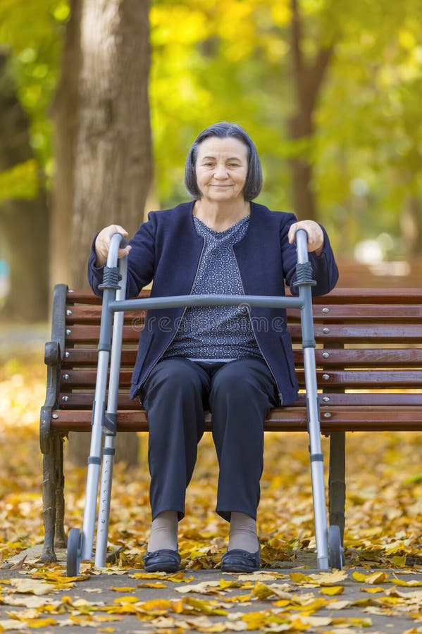 Woman with Walker on Bench Smiling at Camera Outdoors Stock Image ...