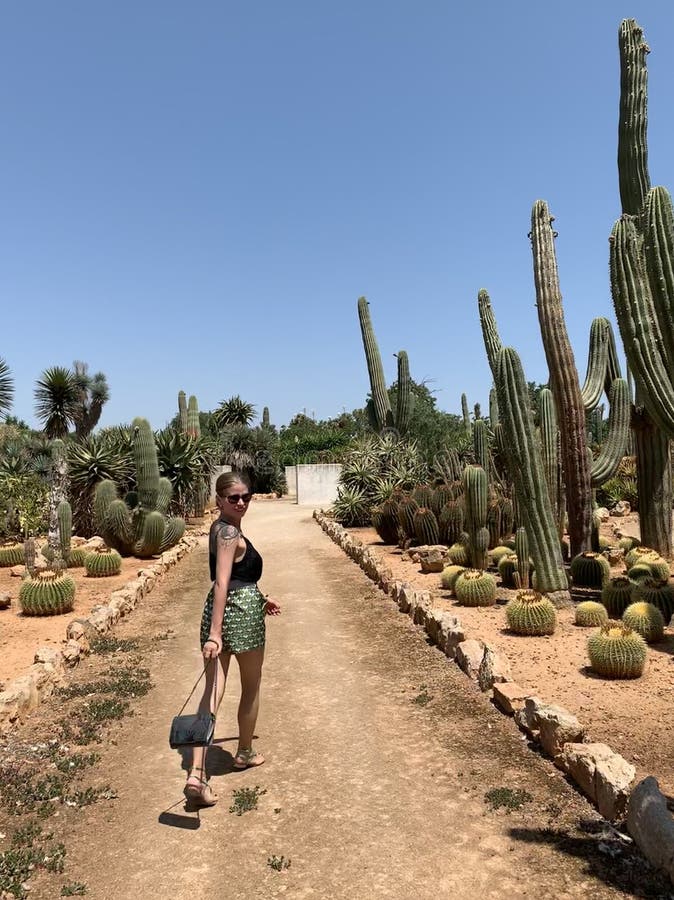 A Woman Walking in a Botanical Garden with Cacti. Stock Photo - Image ...