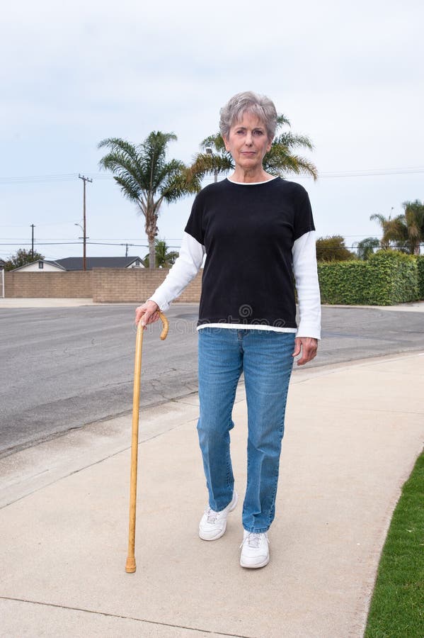 Woman walking with cane stock photo. Image of mature - 25421238